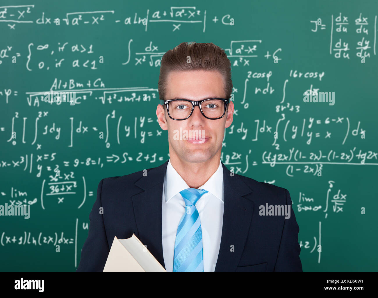 Young Male Lecturer Standing In Front Of Chalkboard Stock Photo - Alamy