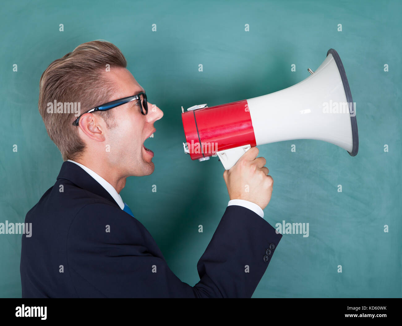 Male Professor Shouting Though Megaphone Against Chalkboard Stock Photo ...
