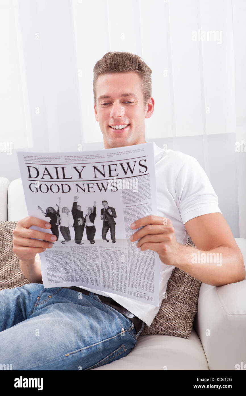 Man Reading Newspaper With The Headline Good News Stock Photo - Alamy
