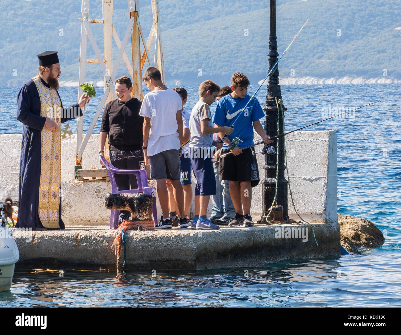 Priest blessing the catch as local boys fish at a fishing festival in ...