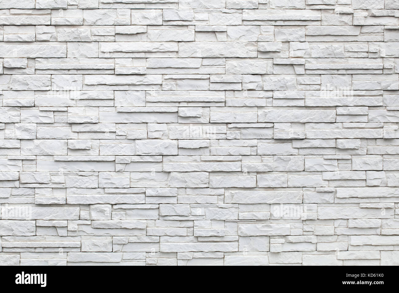 Wall decorated of white stones Stock Photo - Alamy