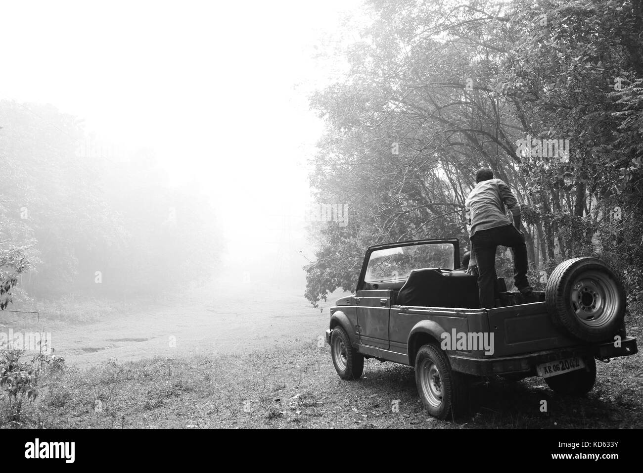 Black & White close up blue old Jeep car parking on the India.man ...