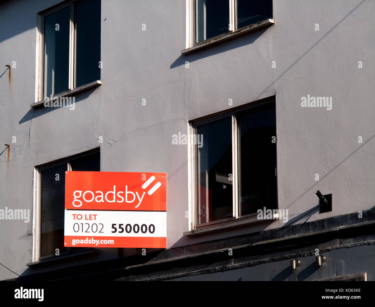 Estate agents office to let advertisement sign over vacant premises ...