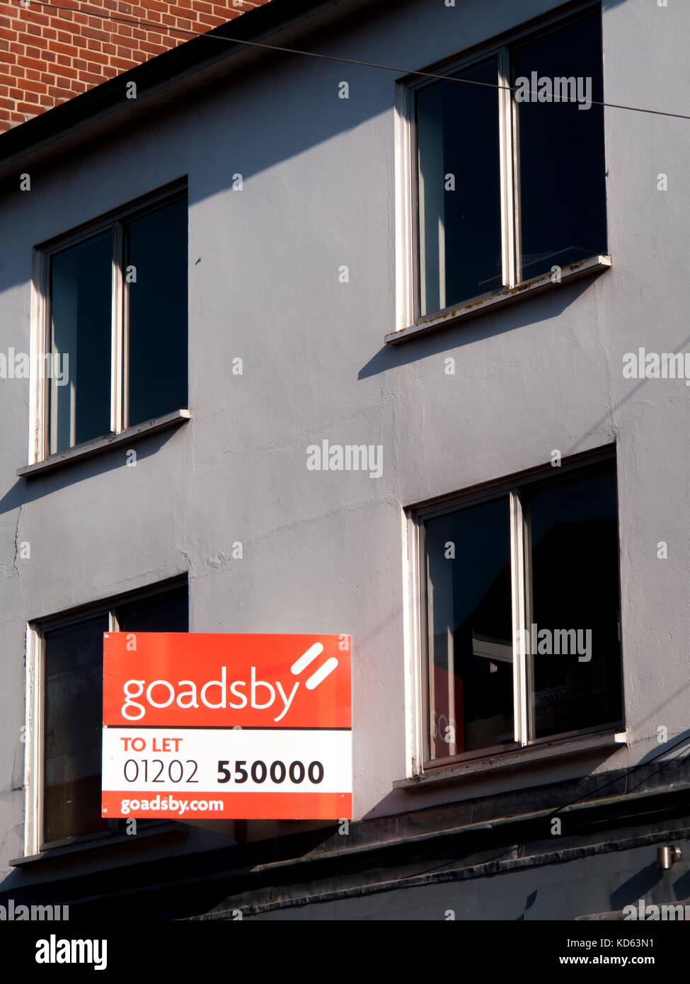 Estate agents office to let advertisement sign over vacant premises ...