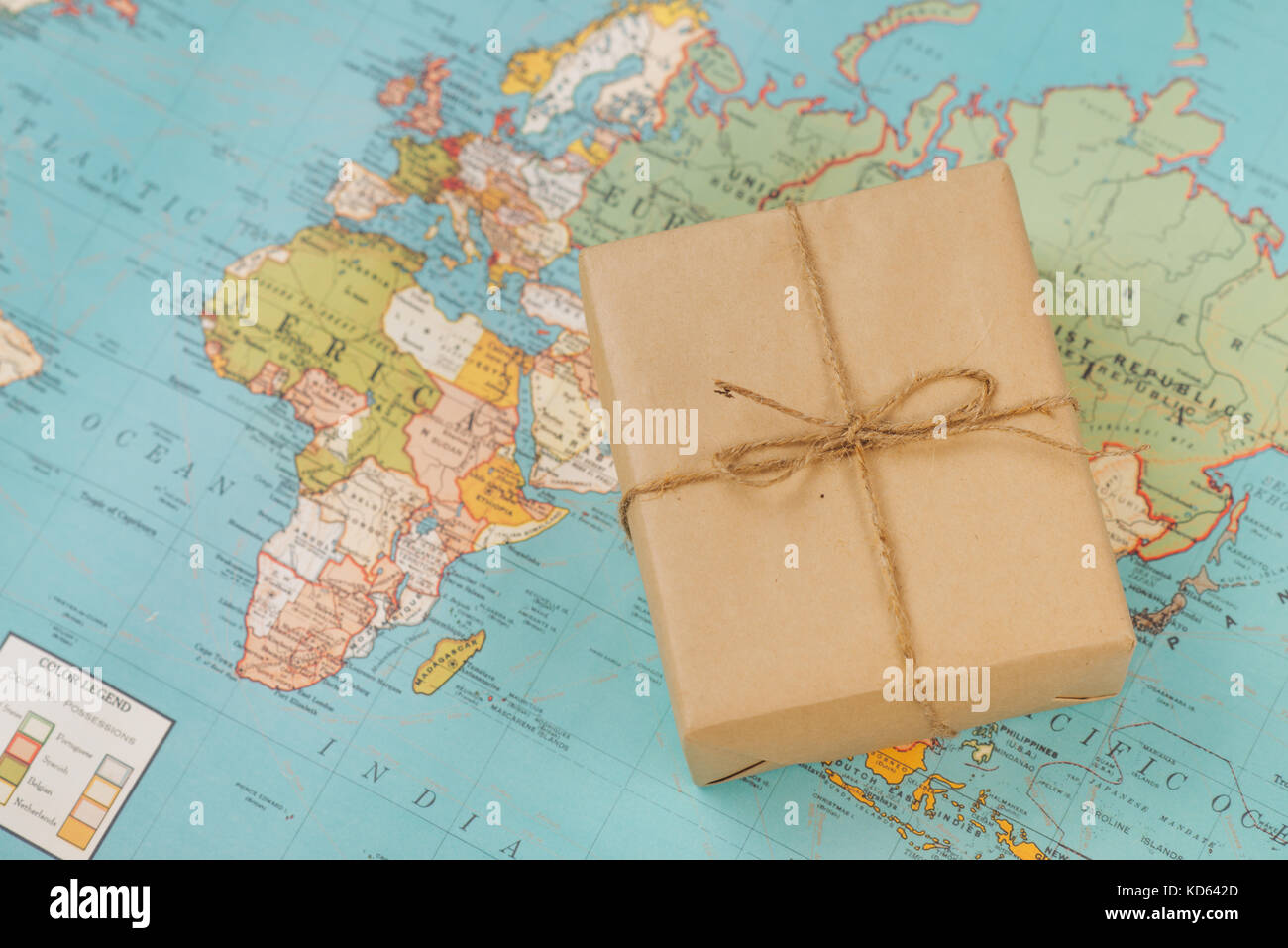 International shipping. Cardboard box on the geographical map ...