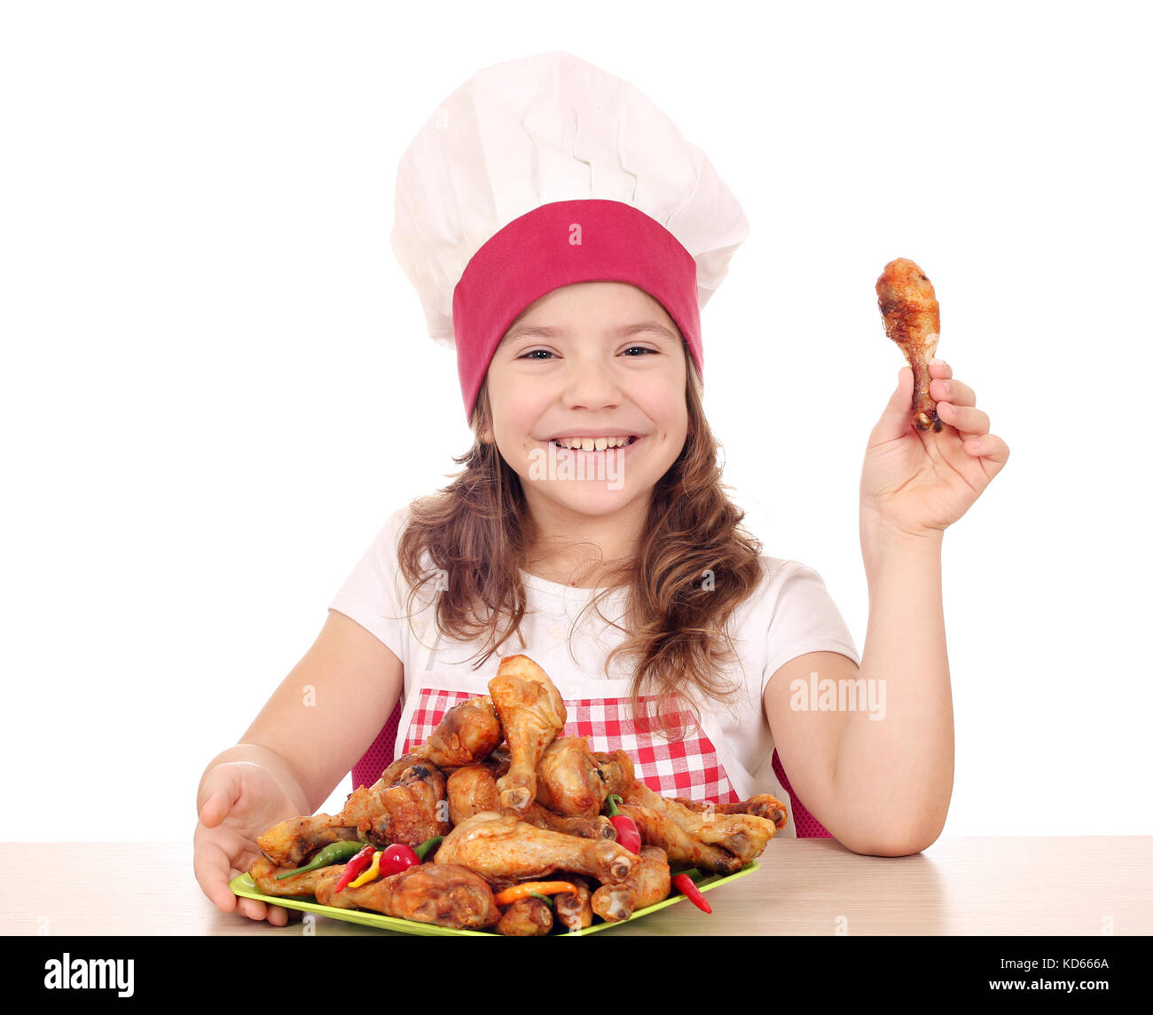 beautiful little girl cook with chicken drumstick Stock Photo - Alamy