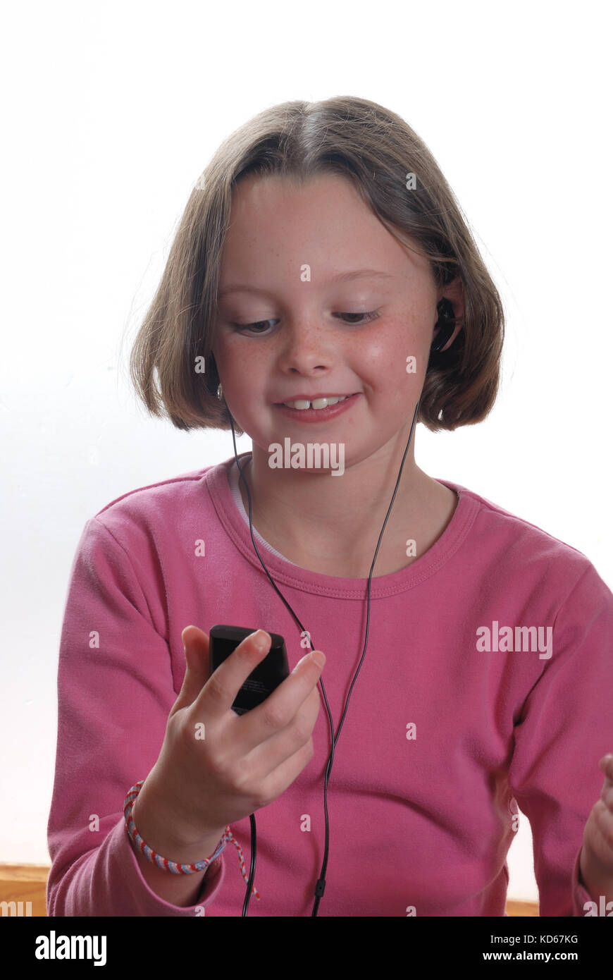 Girl listening to mp3 player Stock Photo - Alamy