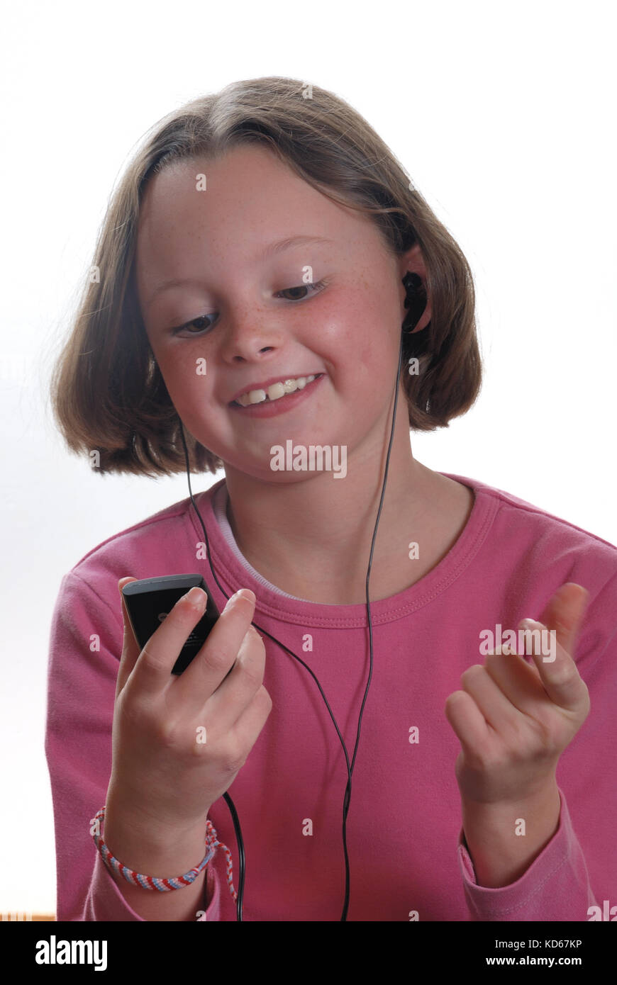 Girl listening to mp3 player Stock Photo - Alamy