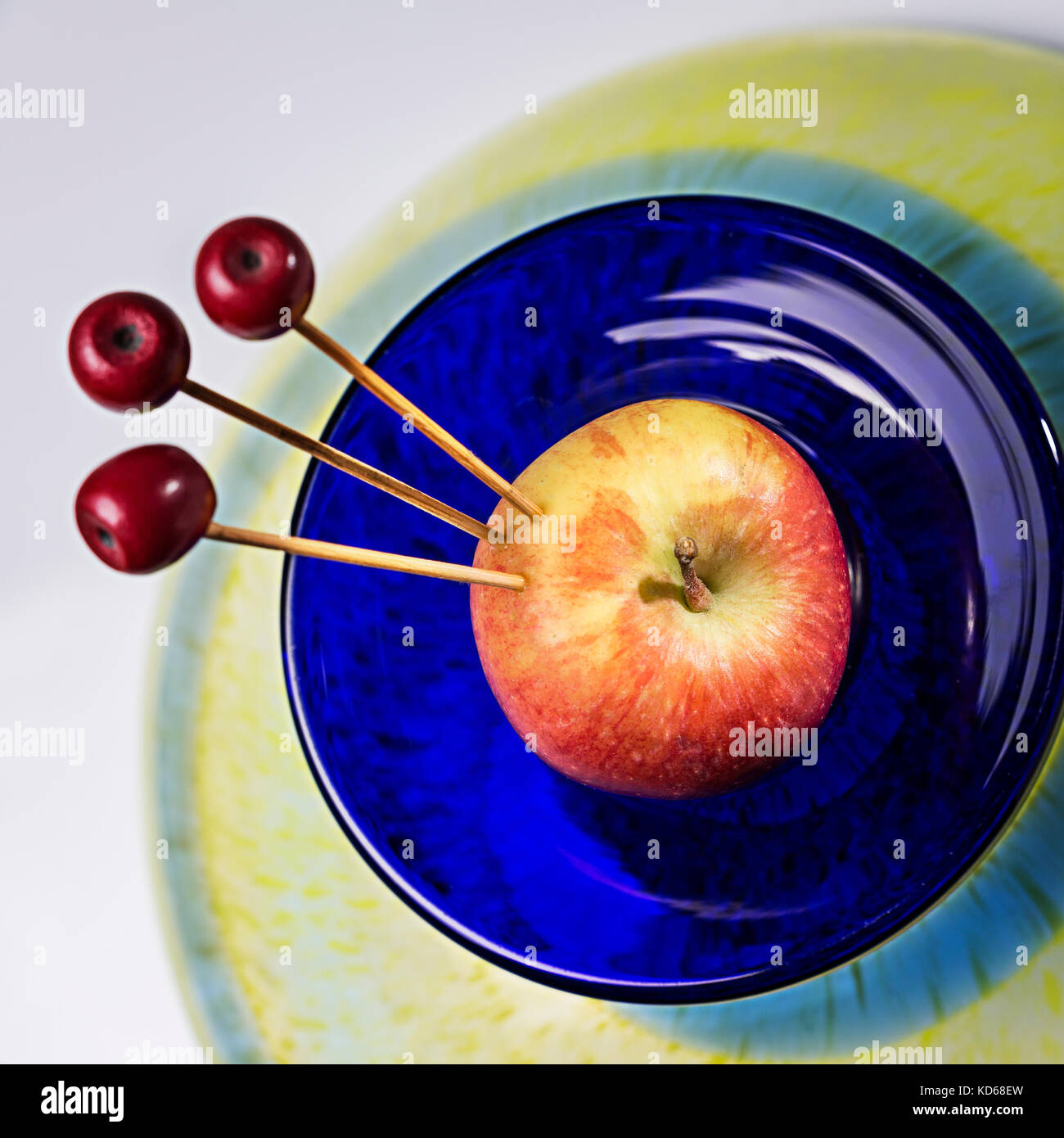 closeup toothpicks on red apple an original plate Stock Photo - Alamy