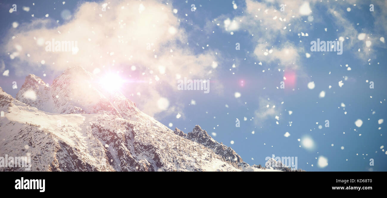 Snow falling against scenic view of snowy mountain range Stock Photo ...