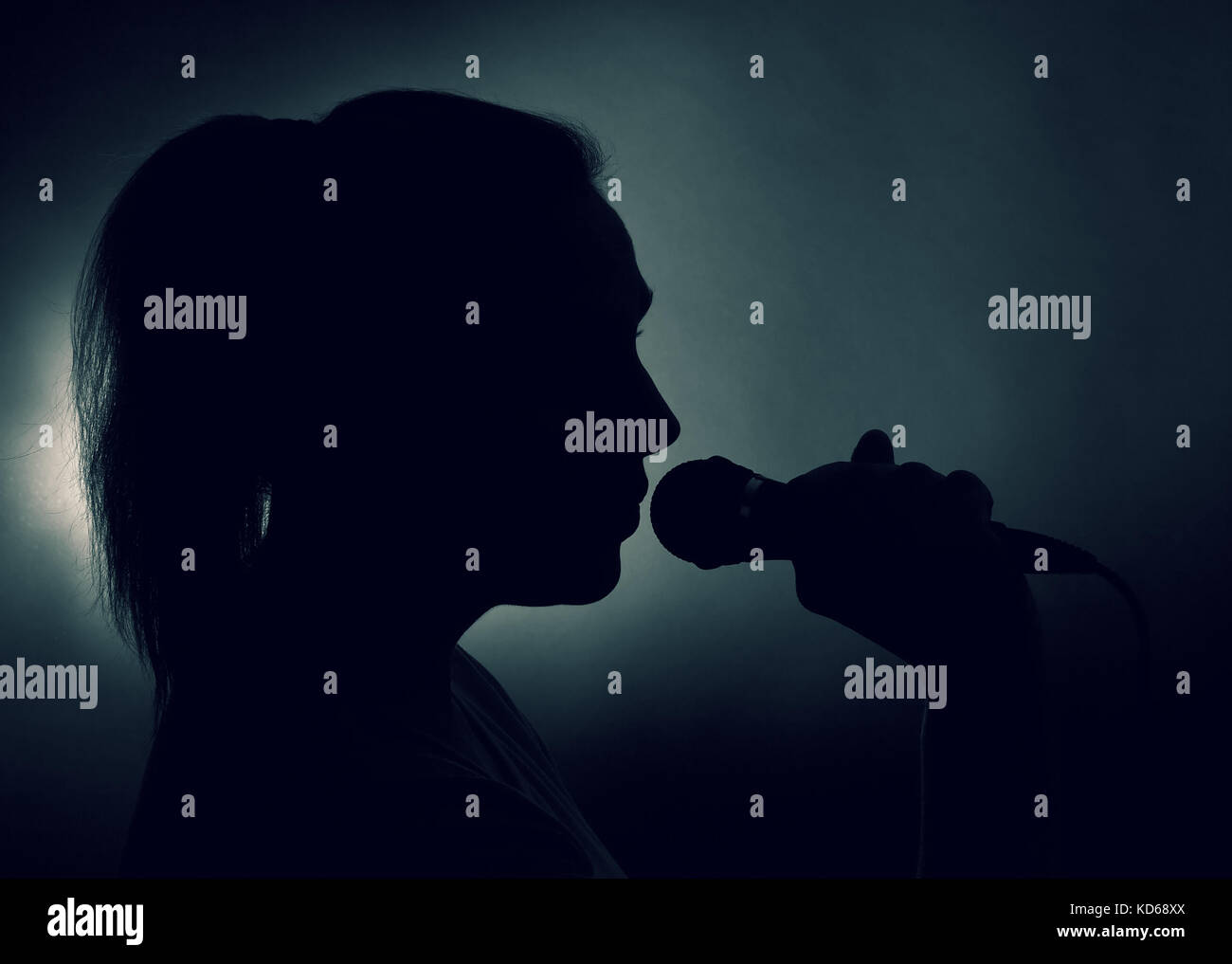 Silhouette of Woman Singing Stock Photo - Alamy
