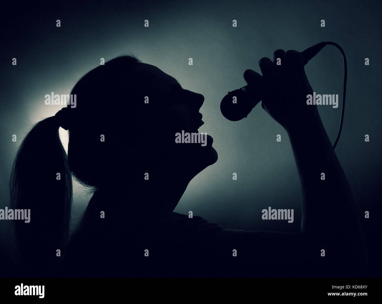 Silhouette of Woman Singing Stock Photo - Alamy