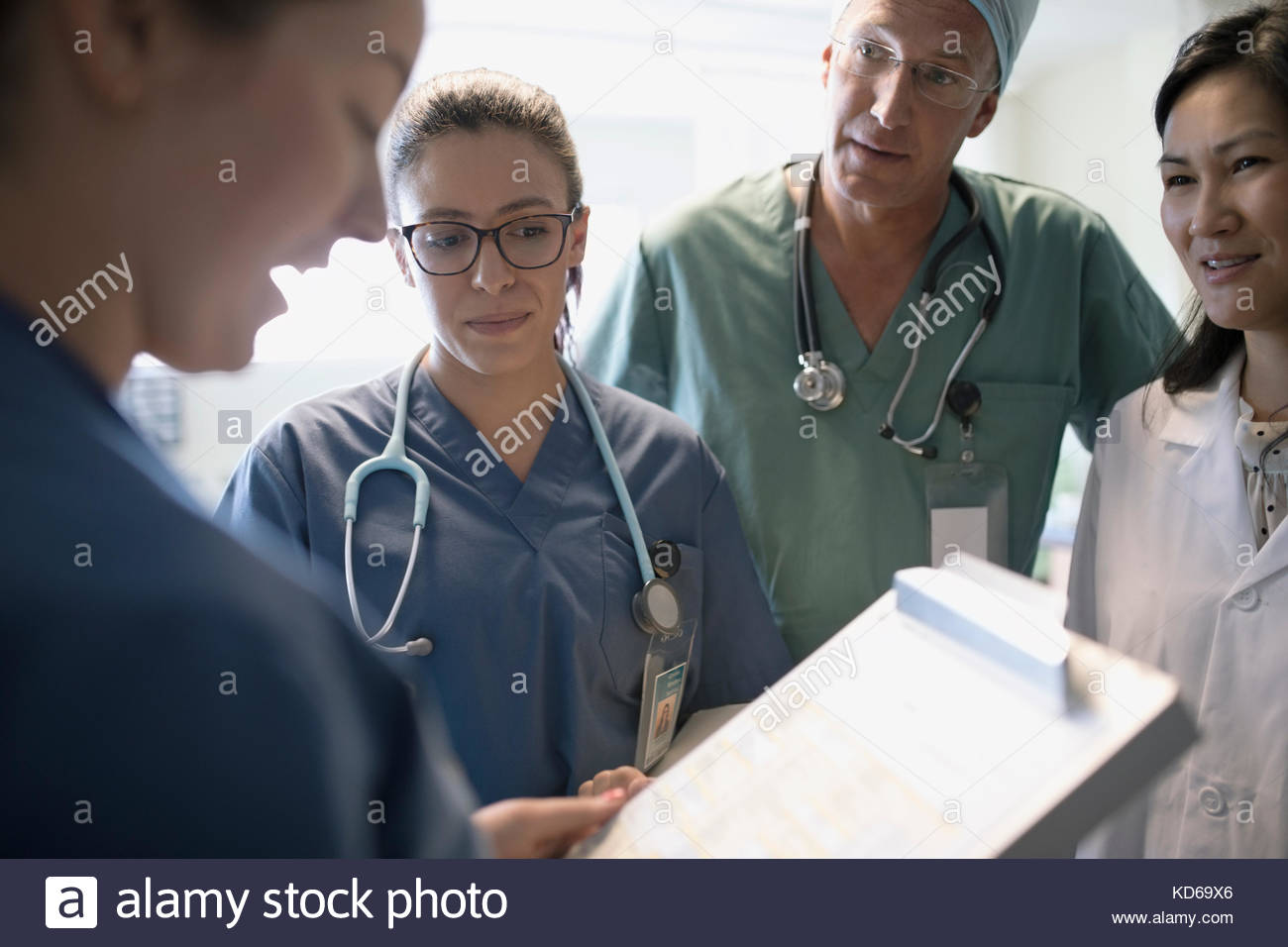Surgeon, doctor and nurses discussing medical record in hospital Stock ...