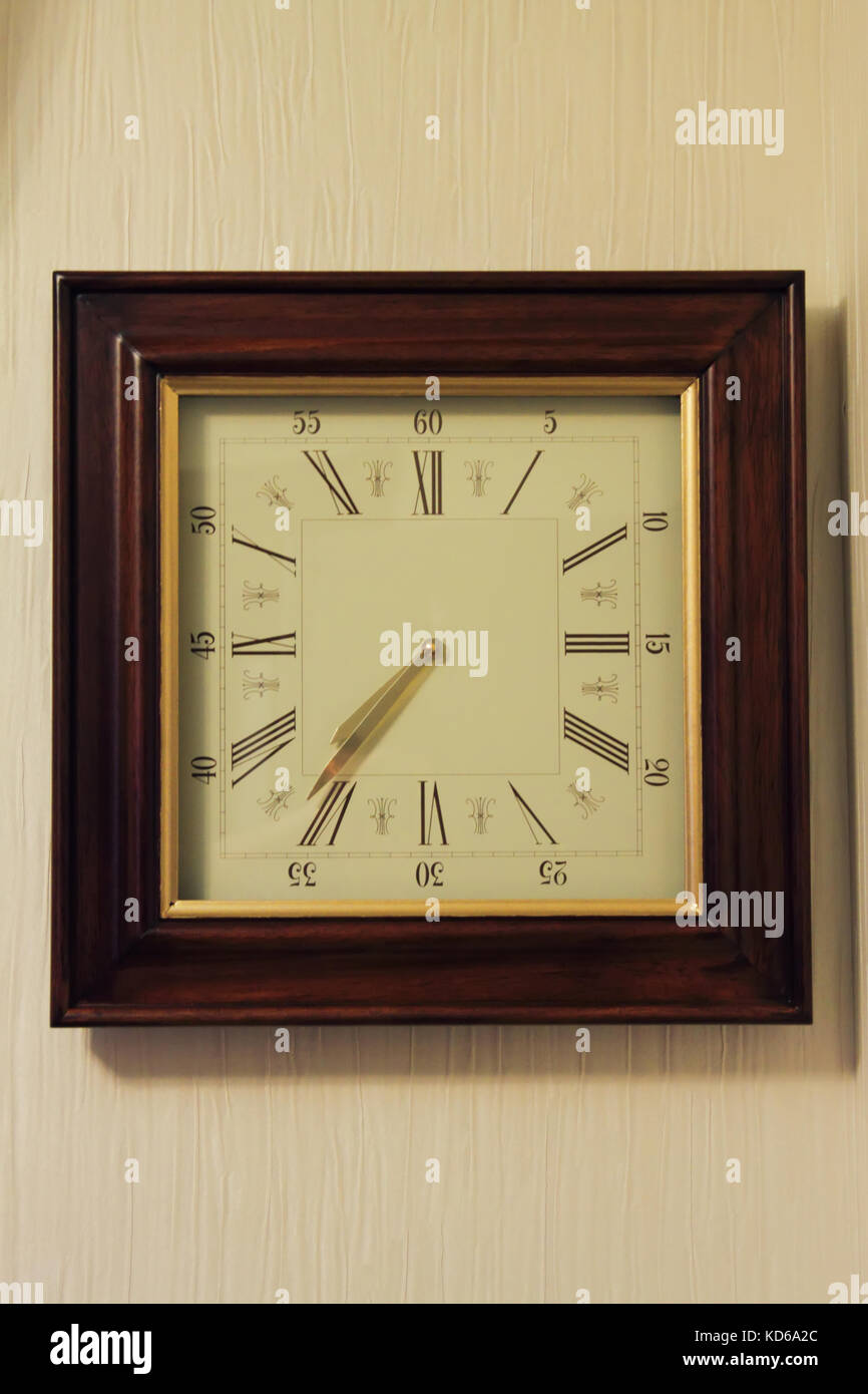 wooden clasical wall clock hanging on the wall Stock Photo - Alamy