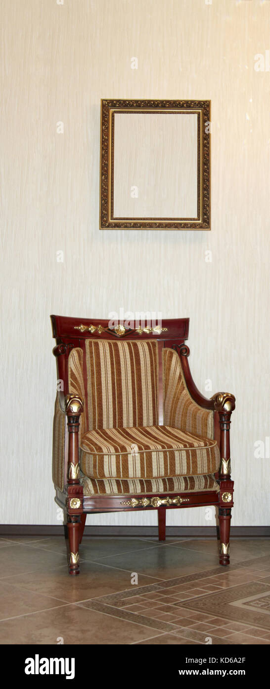 Alone chair with antique frame in minimalist interior Stock Photo - Alamy