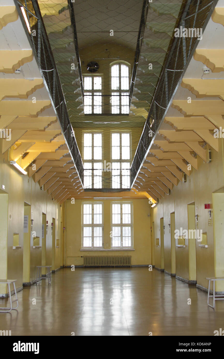 Looking down a deserted aisle lined on both sides with three levels of ...