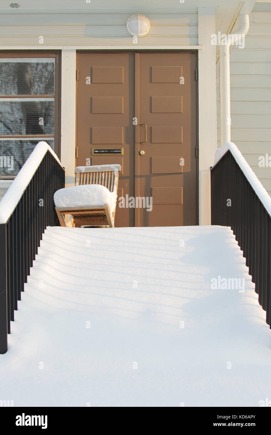 Staircase of porch and chair covered by snow Stock Photo - Alamy