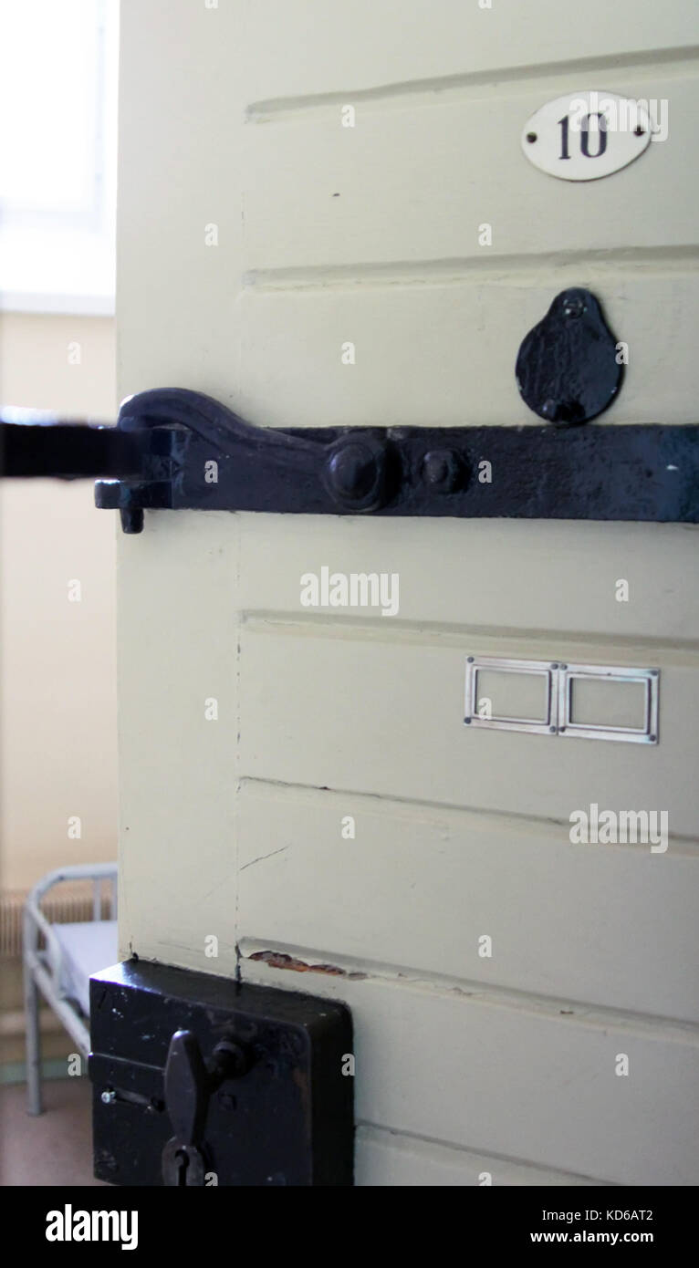 Opened door in prison cell Stock Photo - Alamy