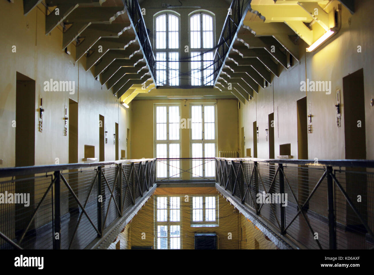 Looking down a deserted aisle lined on both sides with three levels of ...