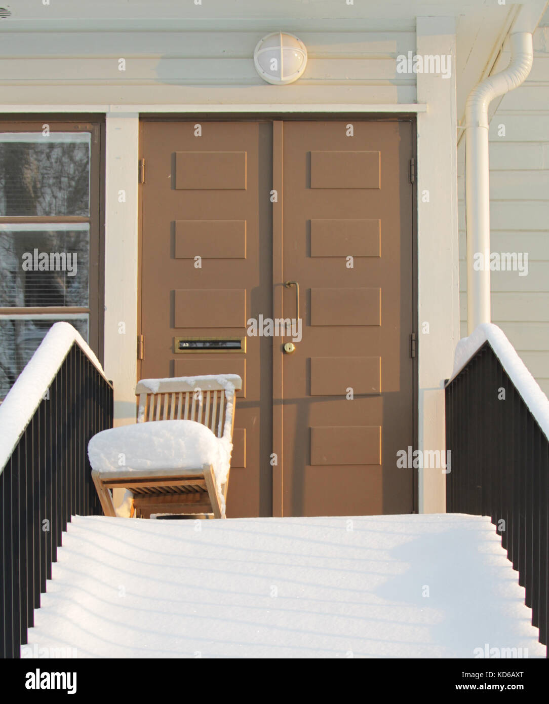Staircase of porch and chair covered by snow Stock Photo - Alamy