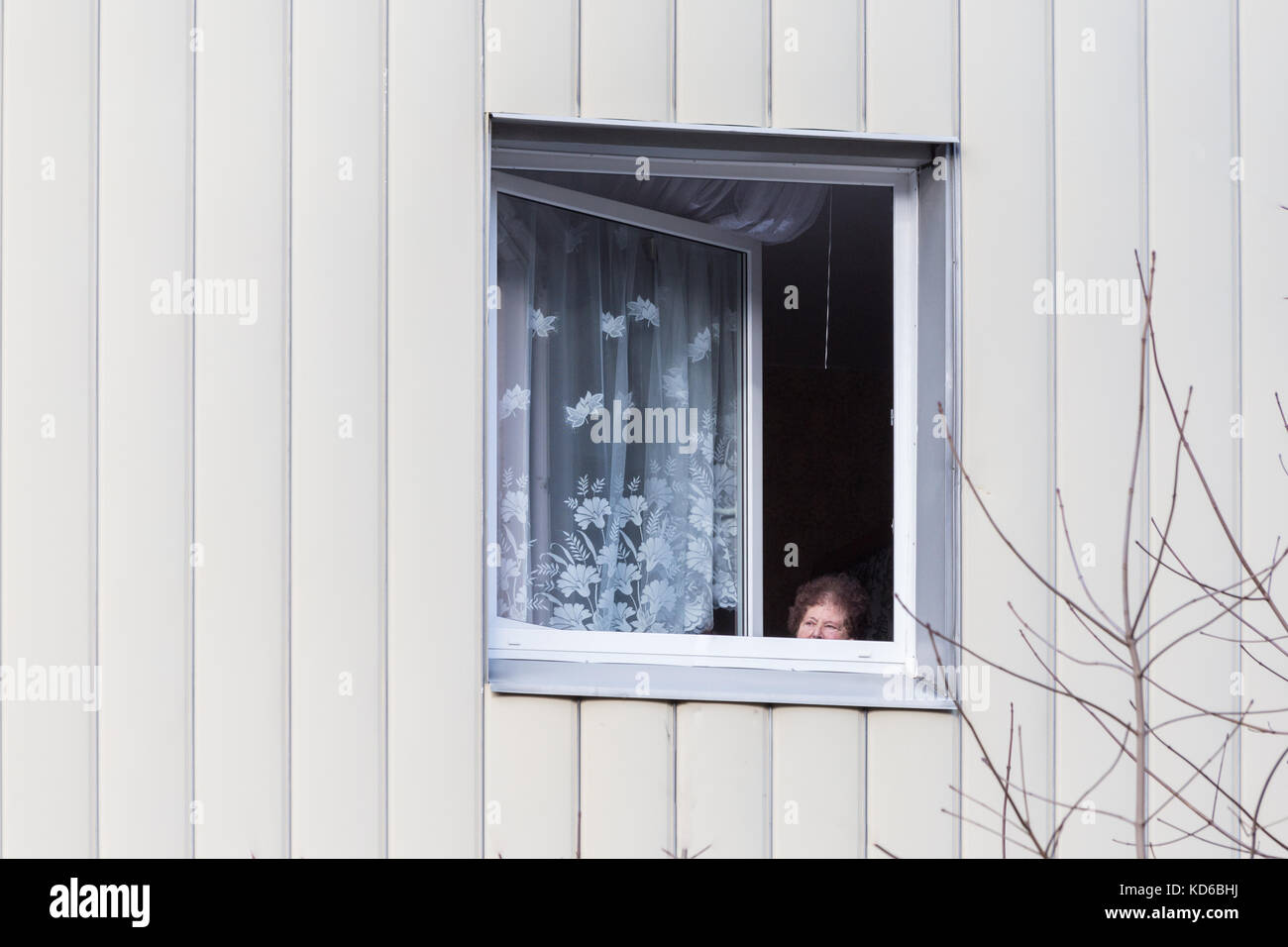 Old woman hiding in her apartment and watching outside life Stock Photo ...