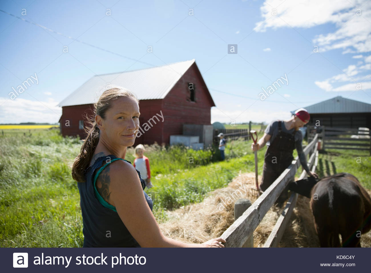 Portrait smiling female farmer at fence on sunny farm Stock Photo - Alamy Portrait smiling female farmer at fence on sunny farm Stock Photo - Alamy