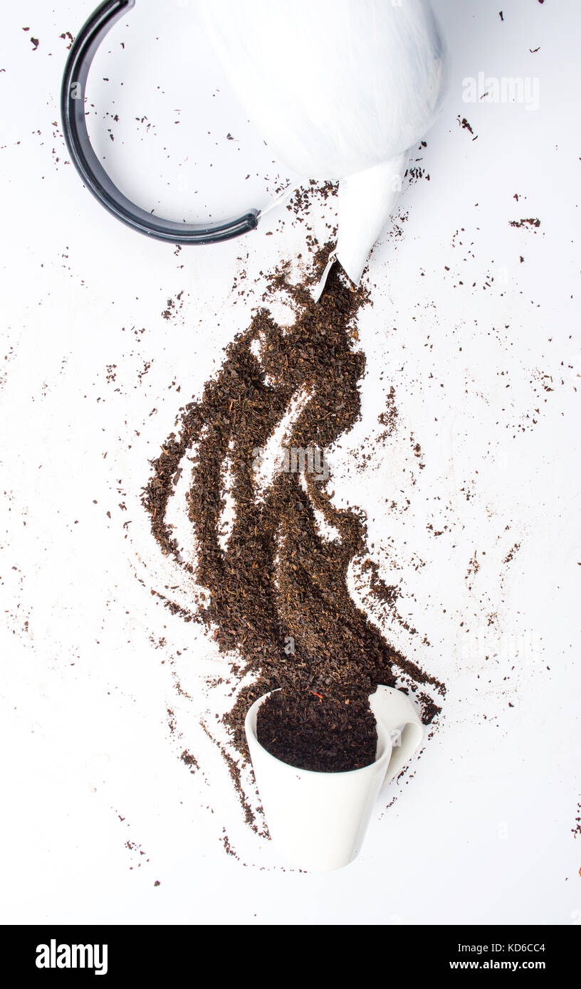Black tea grains falling into teacup from a kettle Stock Photo - Alamy
