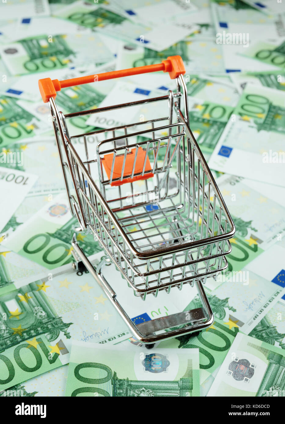 Shopping cart on Euro banknotes Stock Photo - Alamy
