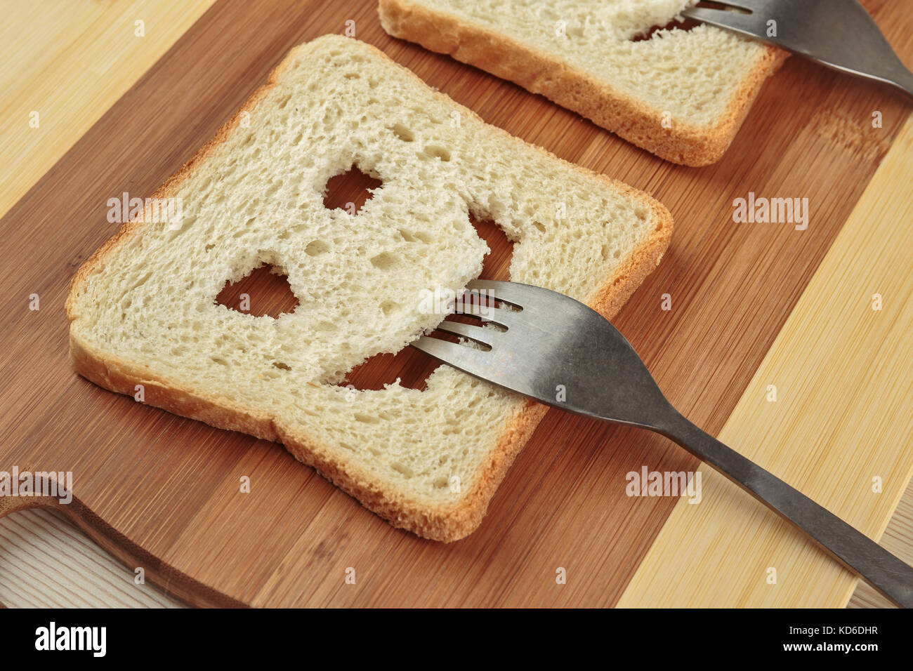 Happy toast with a fork in her mouth on a cutting board Stock Photo - Alamy
