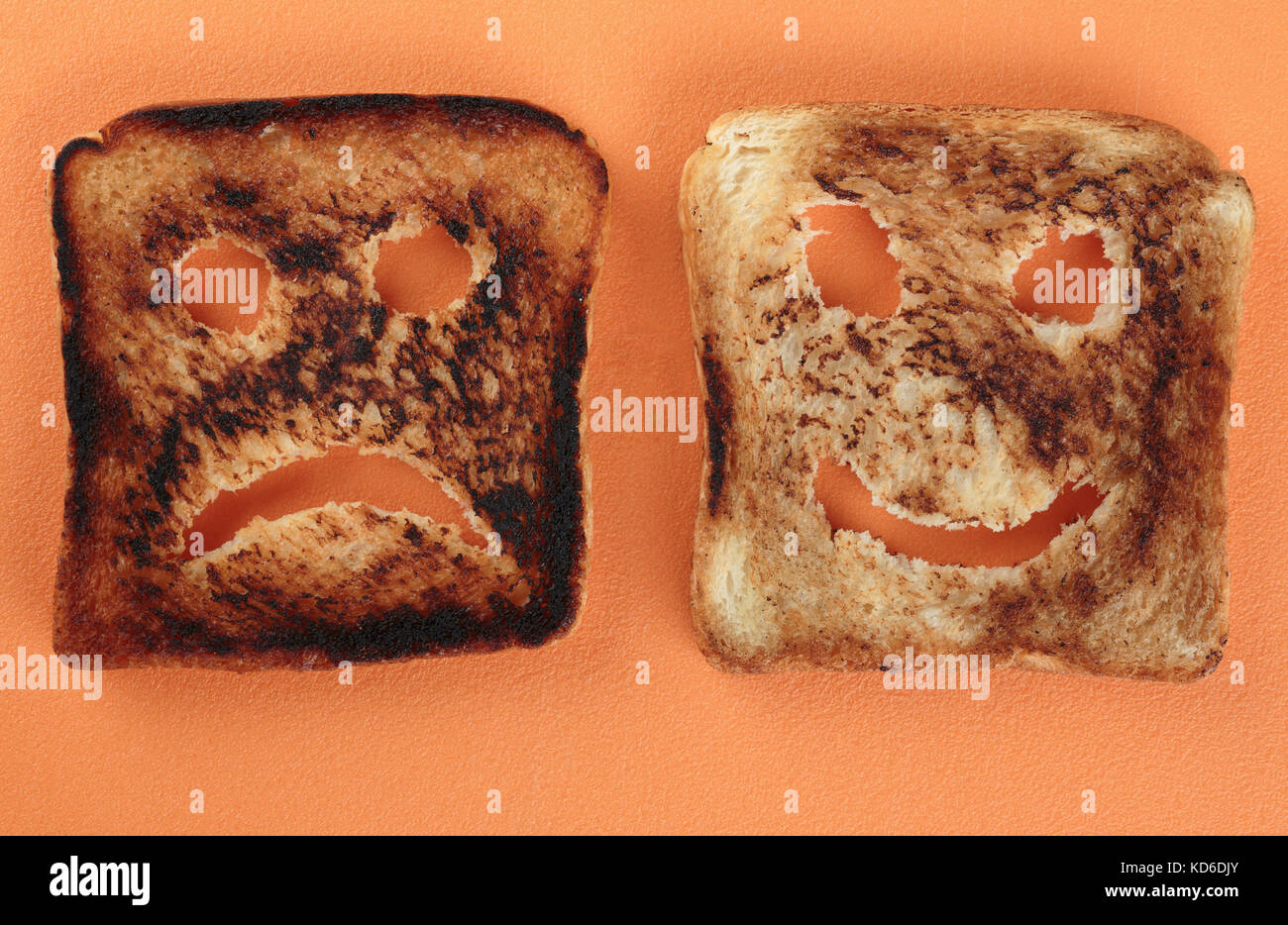 Happy and sad toast on a cutting board Stock Photo - Alamy
