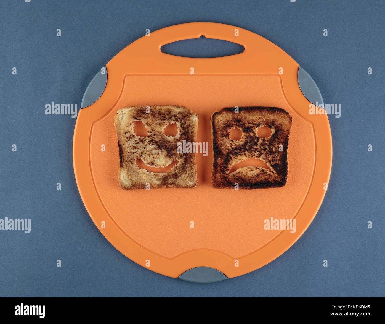 Happy and sad toast on a cutting board Stock Photo - Alamy