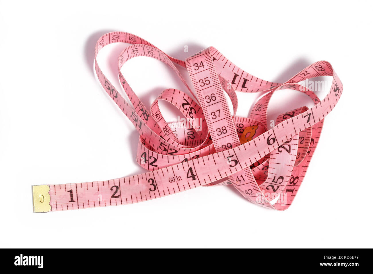 Pink tape measure rolled on white background Stock Photo - Alamy