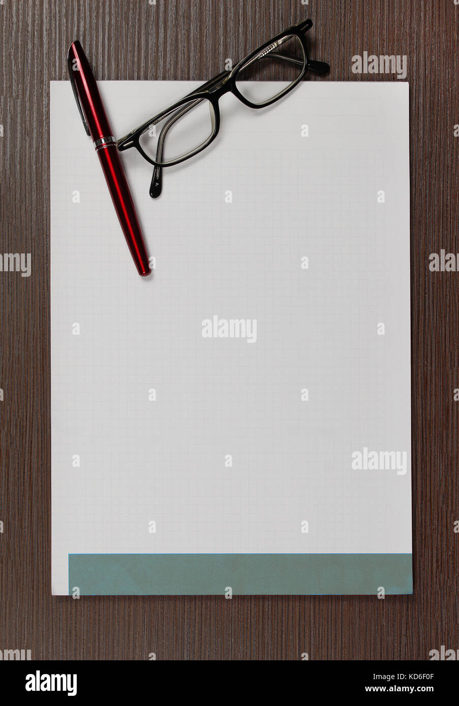White blank notepad page with eyeglasses and writing pen in corner of ...