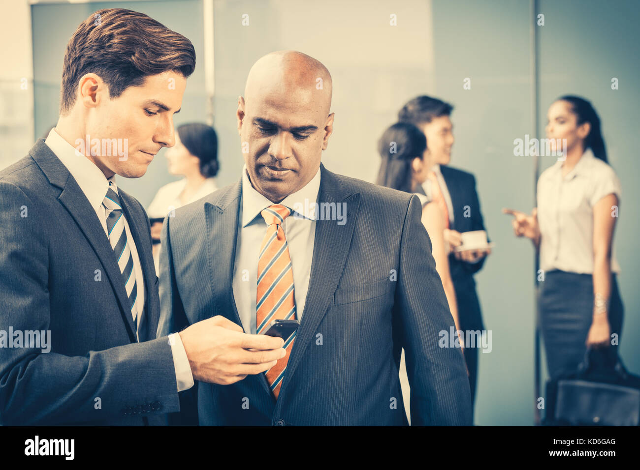 Mixed Asian and Caucasian business team meeting Stock Photo - Alamy