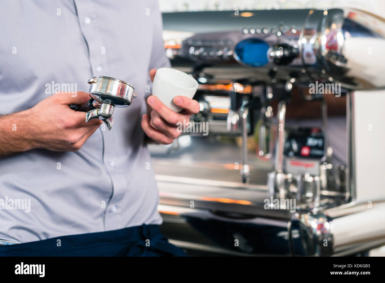Waiter preparing espresso at an automatic coffee machine Stock Photo ...