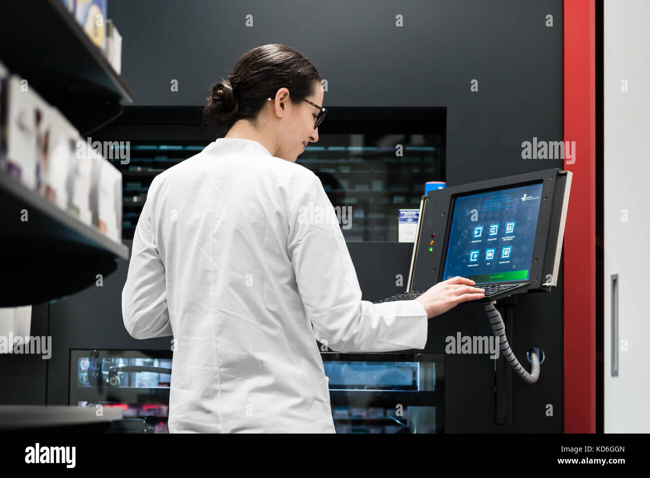 pharmacist using a computer while managing the drug stock in pha Stock ...