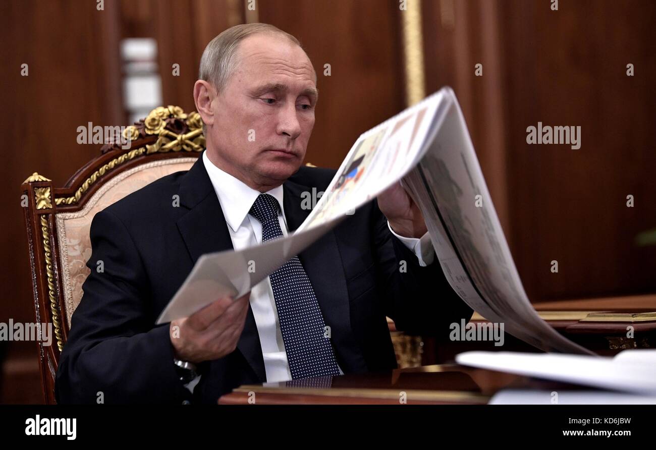 Russian President Vladimir Putin examines voting results during a ...