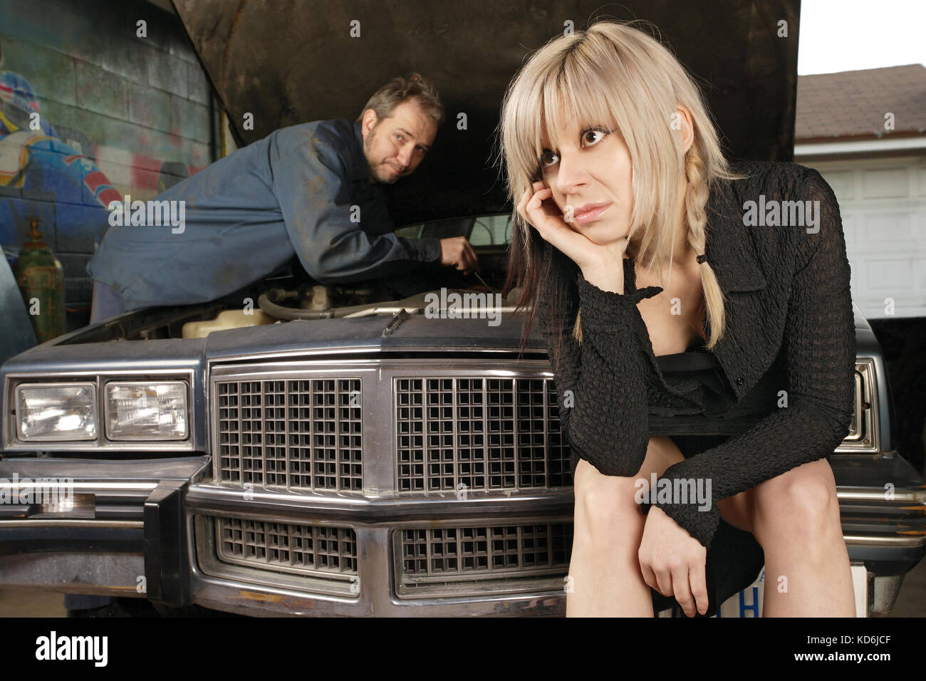Photo of a frustrated blond woman in her thirties waits for a mechanic ...
