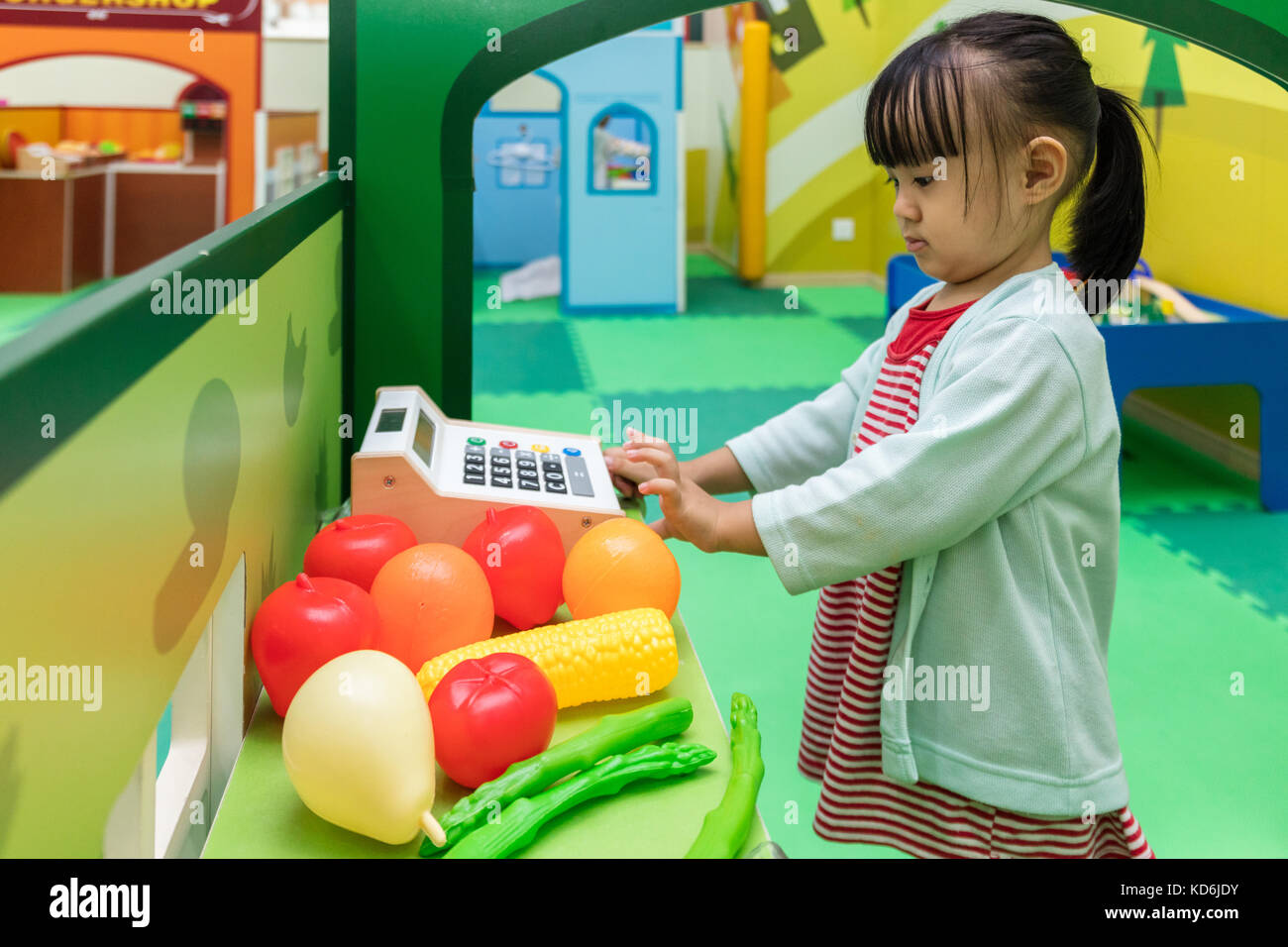 Asian Chinese little girl role-playing at fruits store at indoor ...