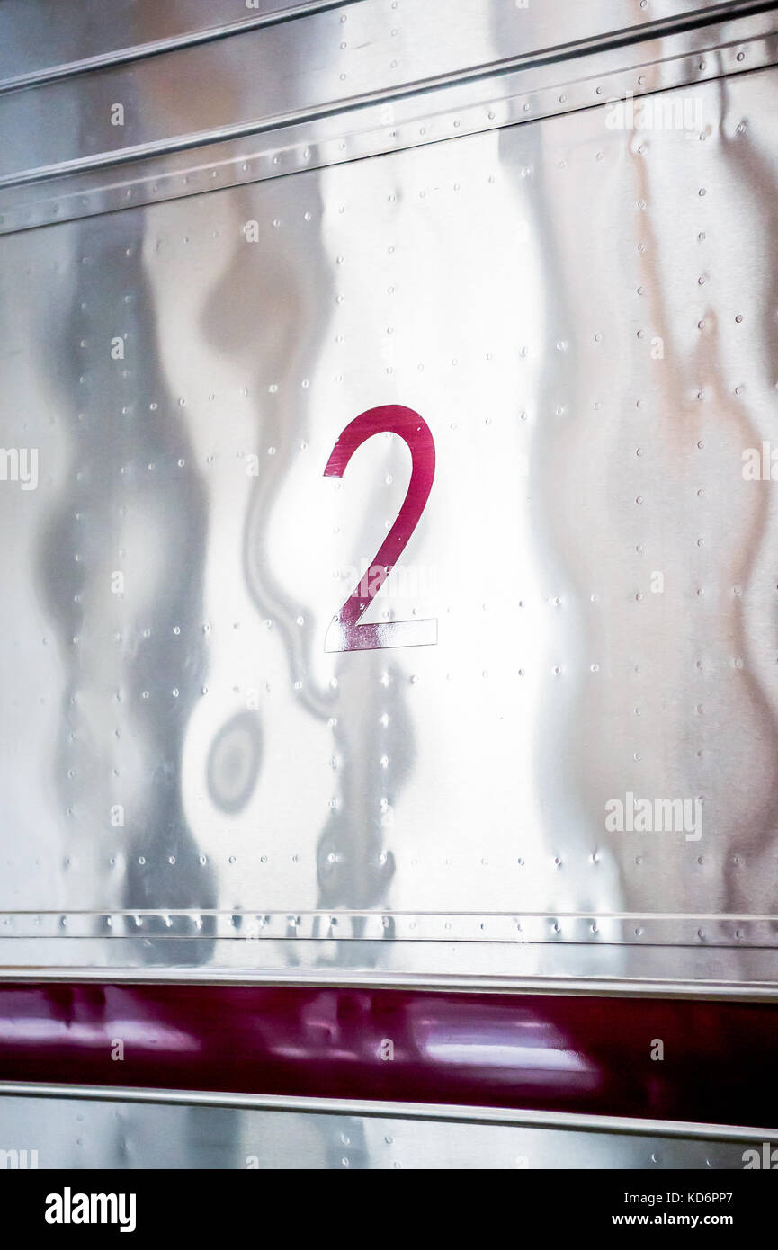 Shiny metal surface with number 2 written on the carriage of a train in ...