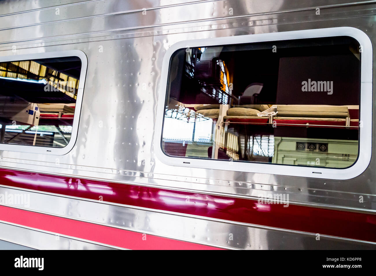 Reflections in the shiny window of a train carriage at Hua Lamphong ...