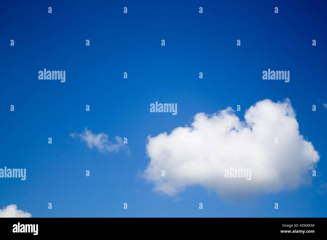 Small white cloud on a blue sky Stock Photo - Alamy