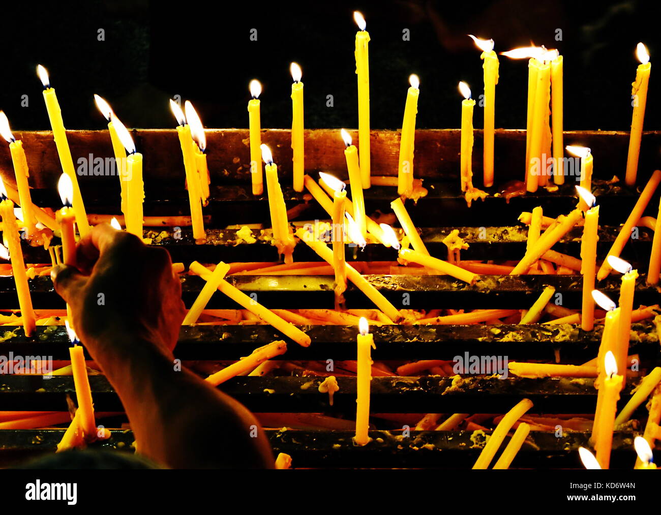 Buddhism hand light candle for praying in temple Stock Photo - Alamy