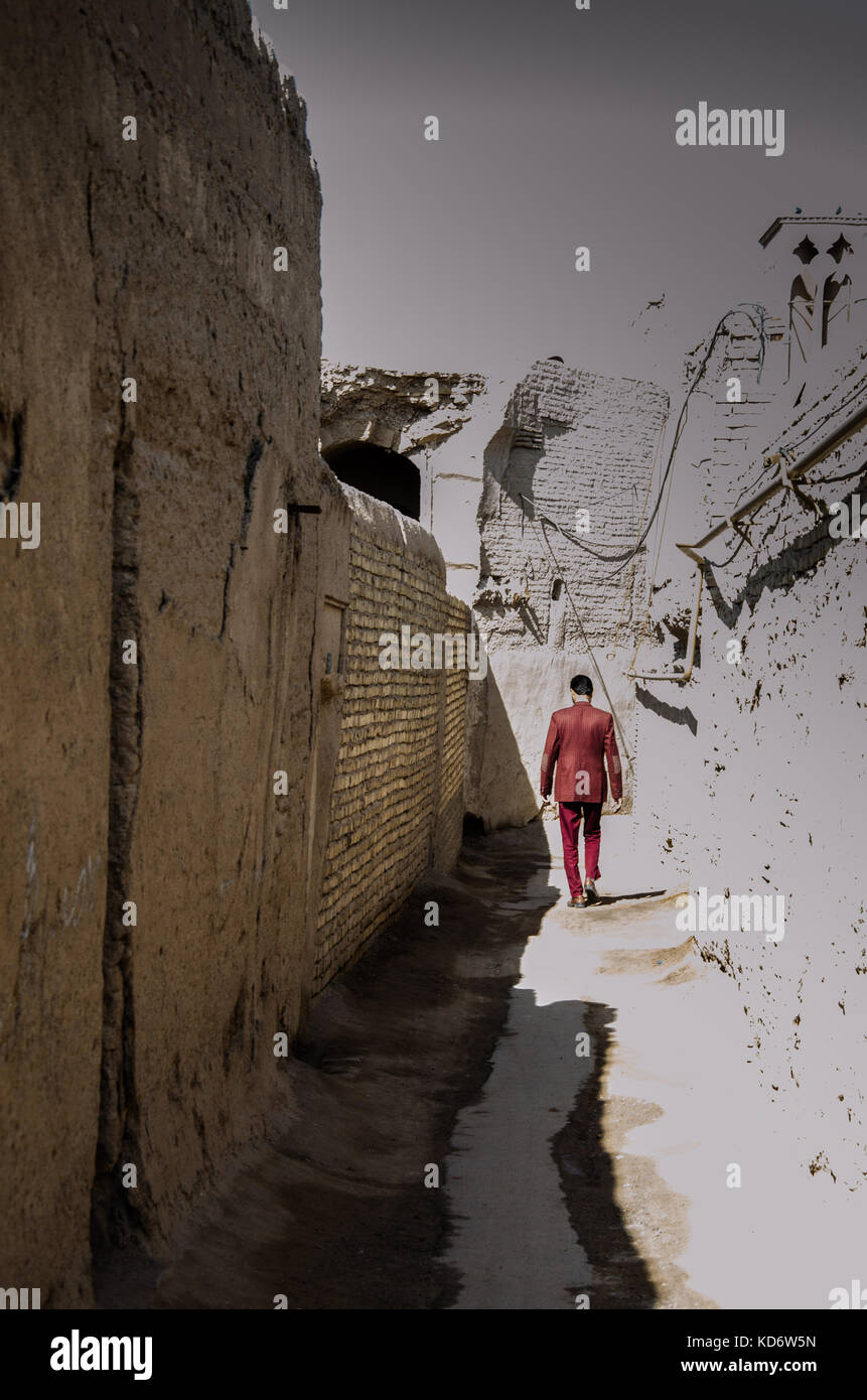 A well dressed man is walking on a dirty street Stock Photo - Alamy