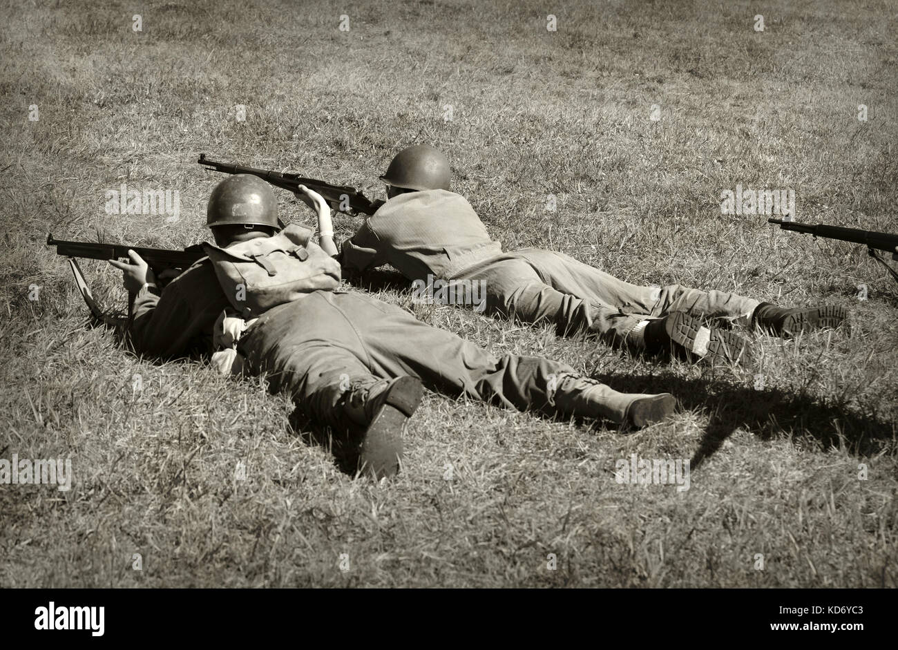 Two World War 2 era soldiers on the ground shooting Stock Photo - Alamy