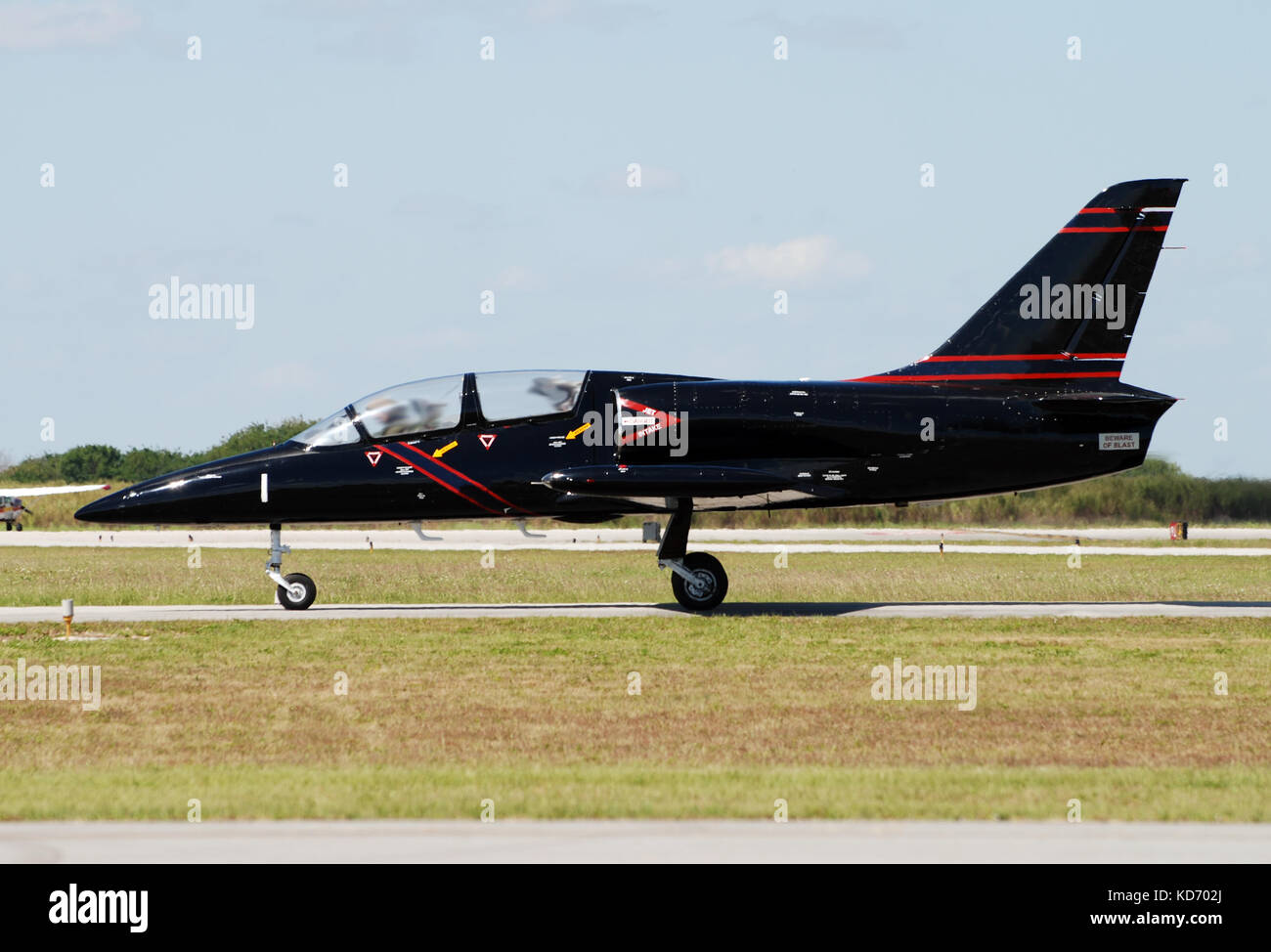 Black colored jet airplane taxiing side view Stock Photo - Alamy