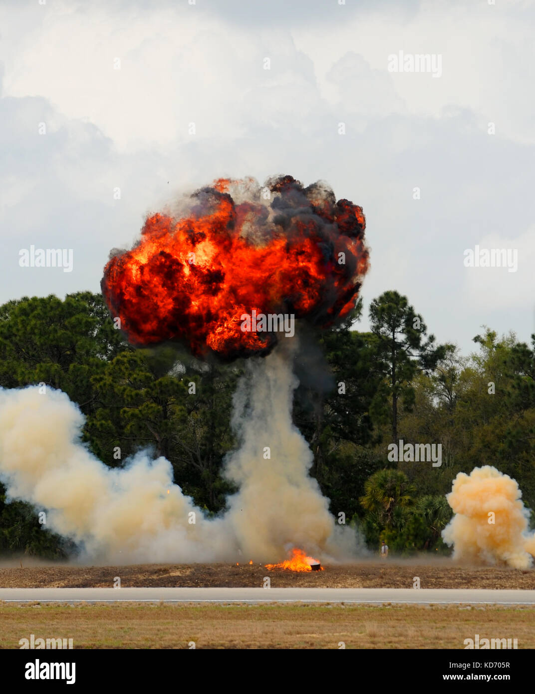 Fiery explosion in field near forested area Stock Photo - Alamy