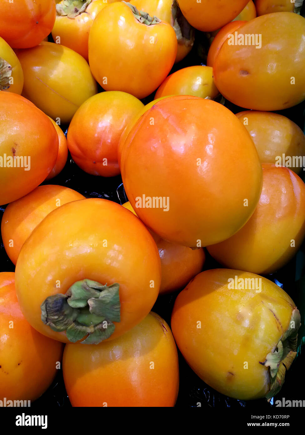 ripe persimones at market Stock Photo - Alamy