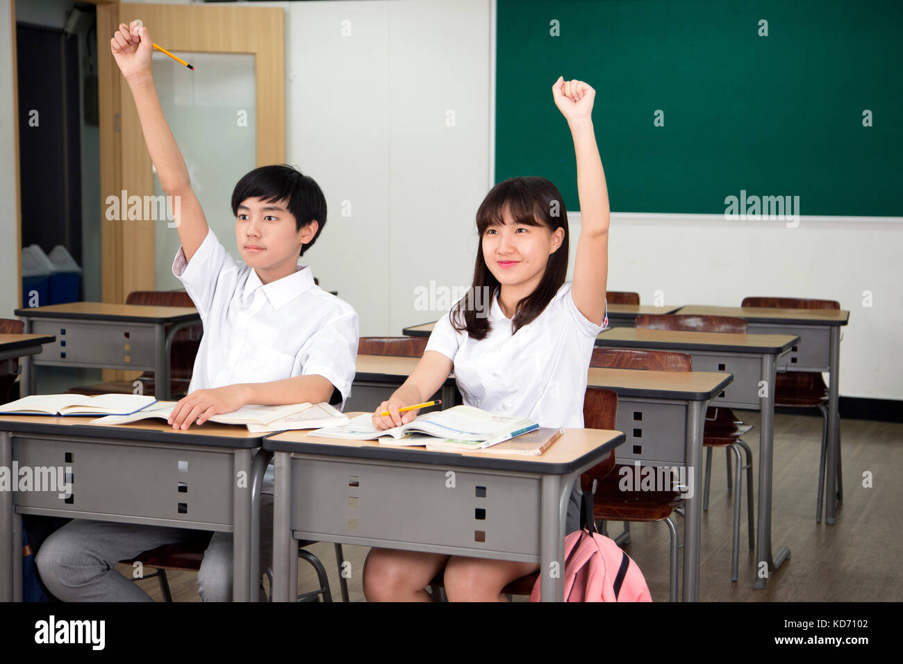Two teenagers classroom hand hi-res stock photography and images - Alamy