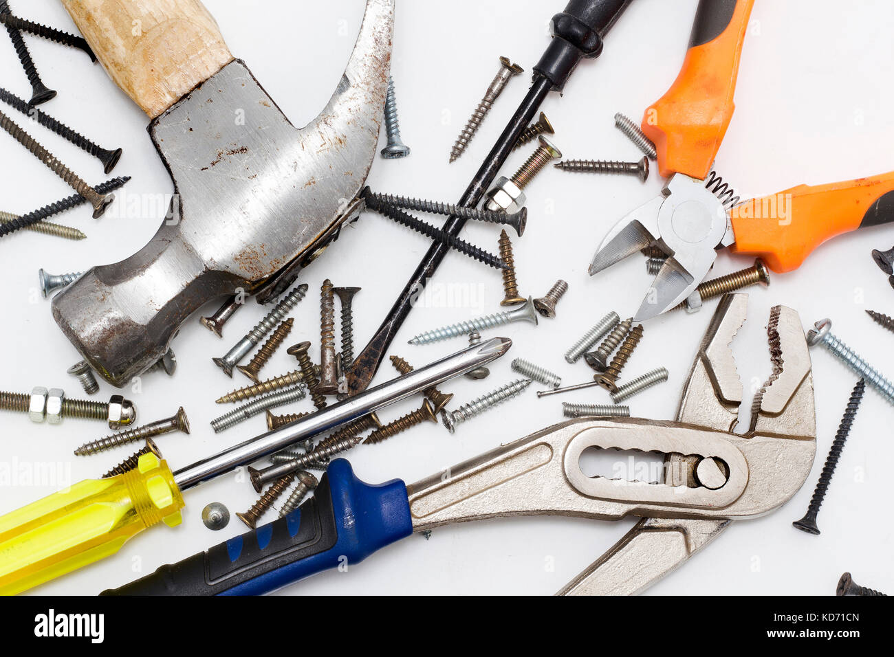 Construction tools with random nails, pins, screws isolated on white ...